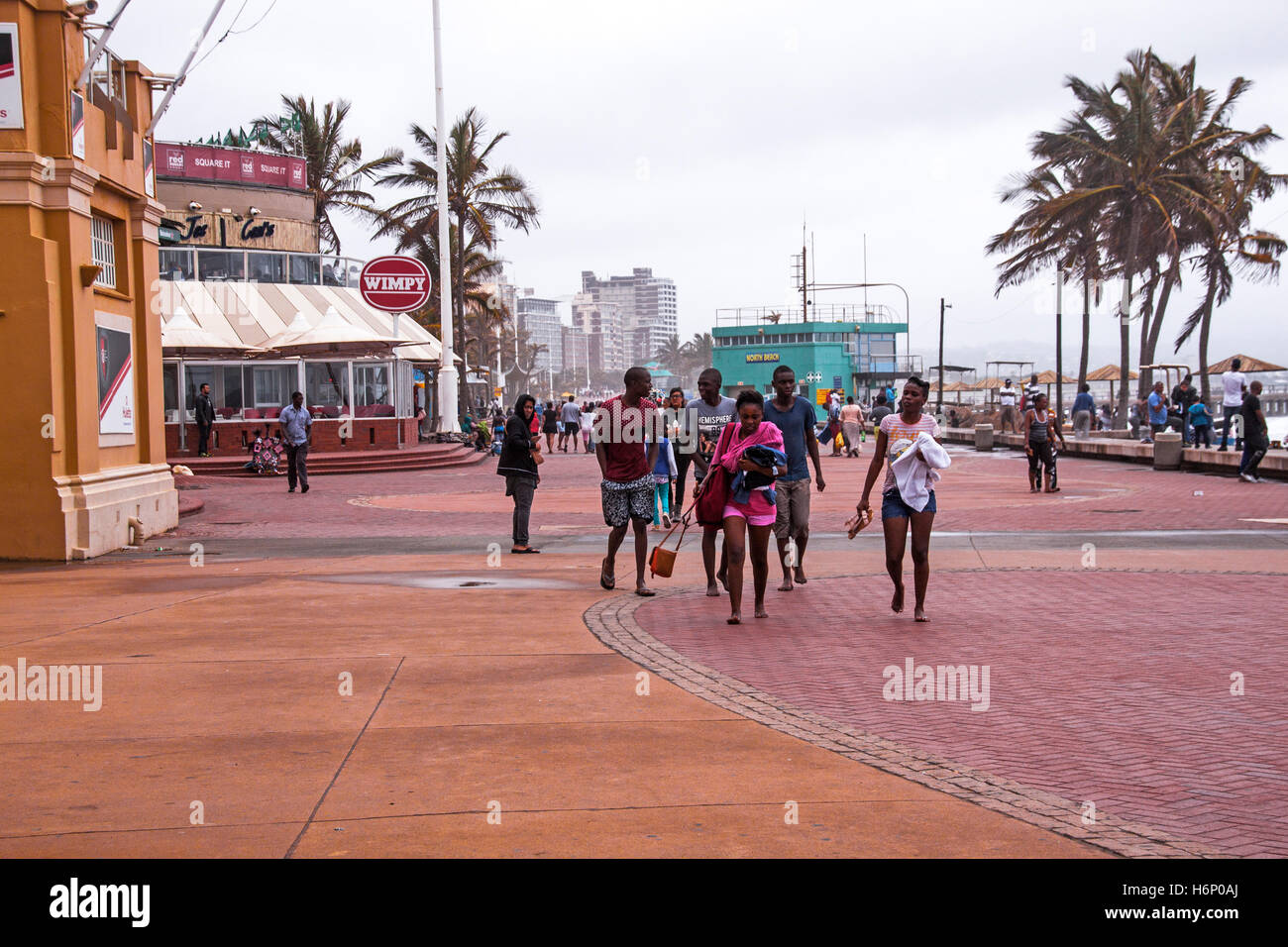 Many unknown people walking along paved promenade at North Beach on ...