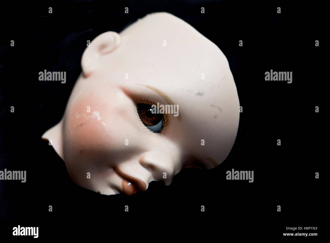 Broken Doll Face and Head on Black Background Stock Photo - Alamy
