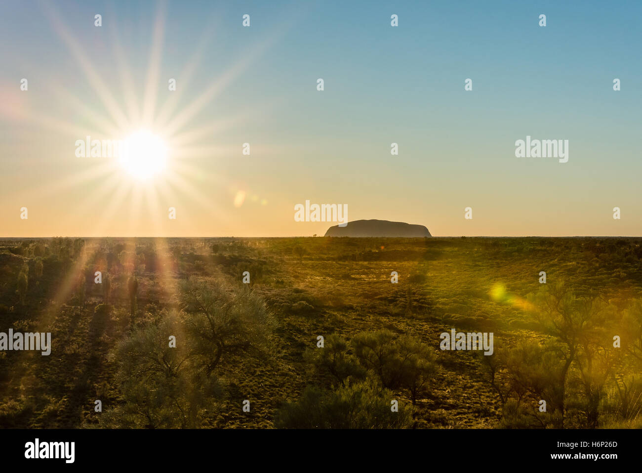 Sunrise at Uluru with clear sky and sun flare Stock Photo - Alamy