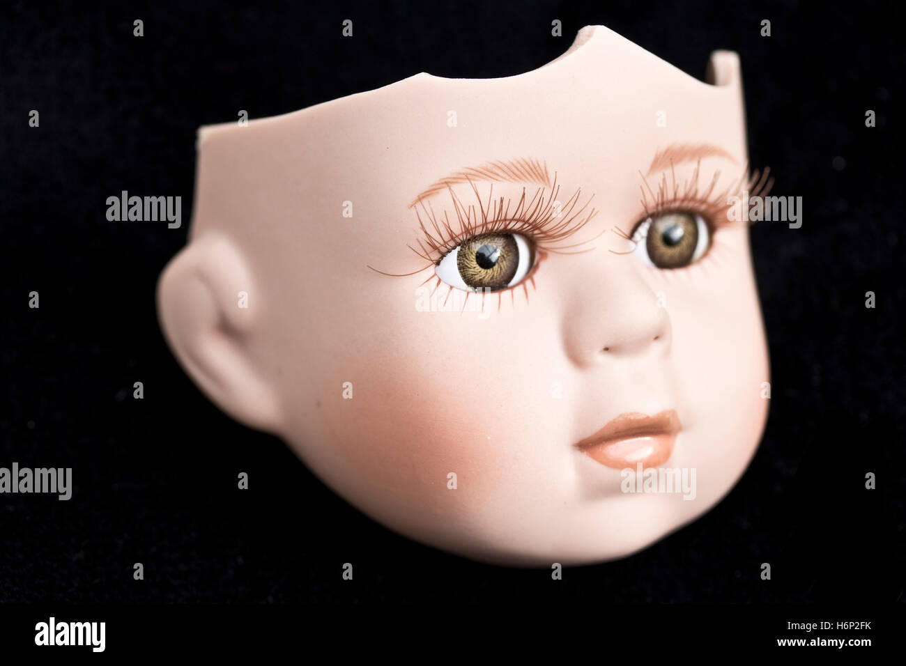 Broken Doll Face and Head on Black Background Stock Photo - Alamy