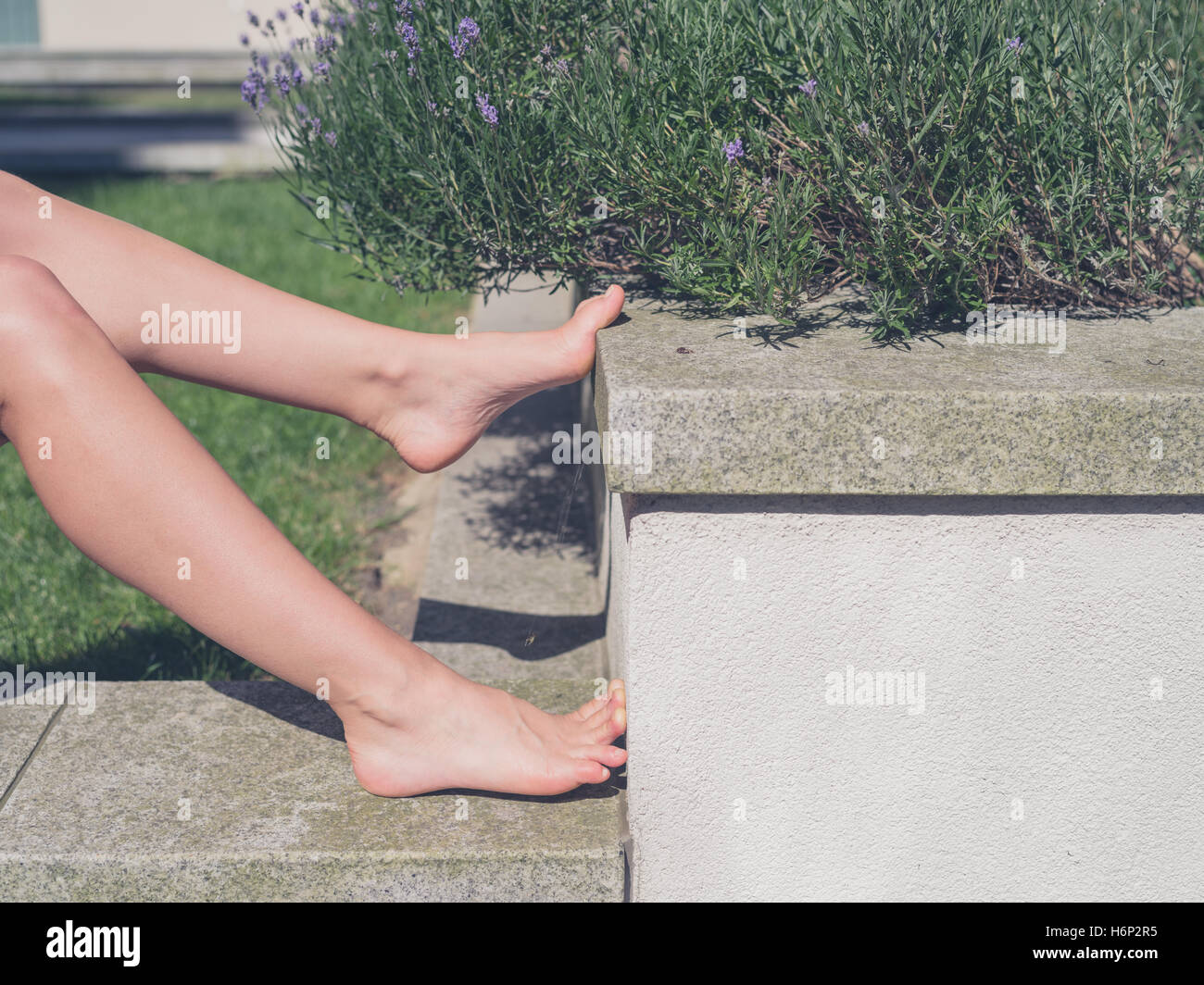 The feet of a young woman as she is relaxing outside Stock Photo - Alamy