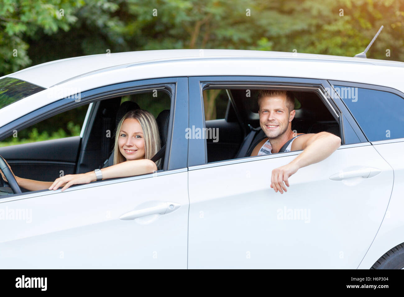 Young happy people enjoying a roadtrip in the car Stock Photo - Alamy