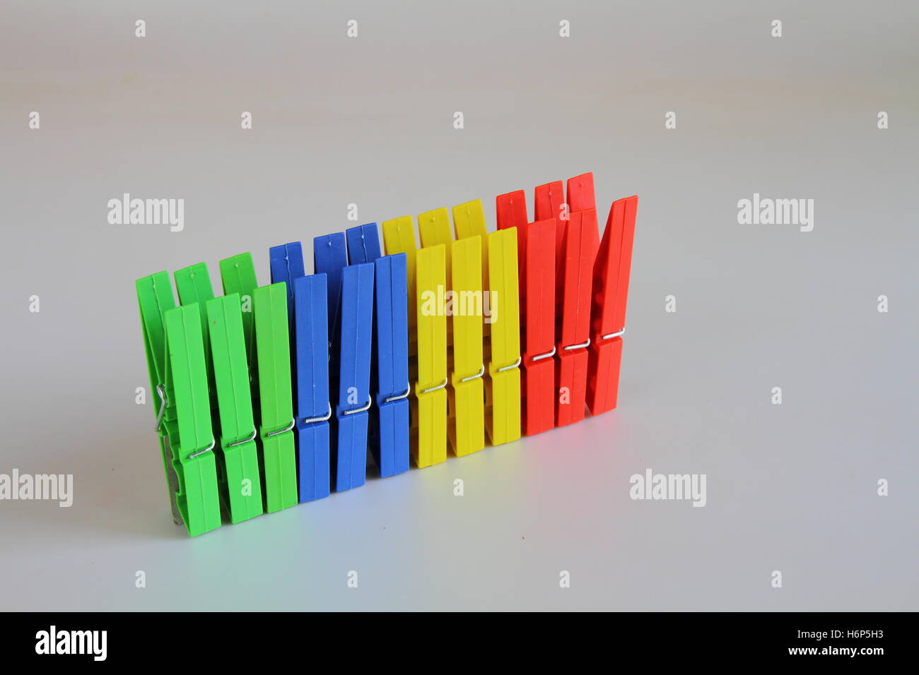 Colorful washing pegs in primary colors isolated on a clear background ...