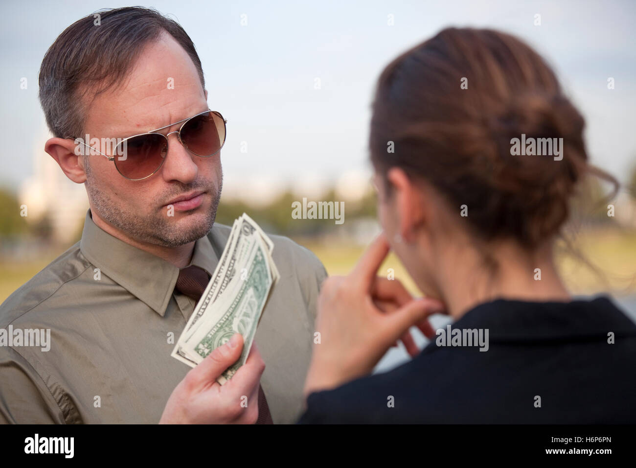 man offers money to a woman Stock Photo - Alamy