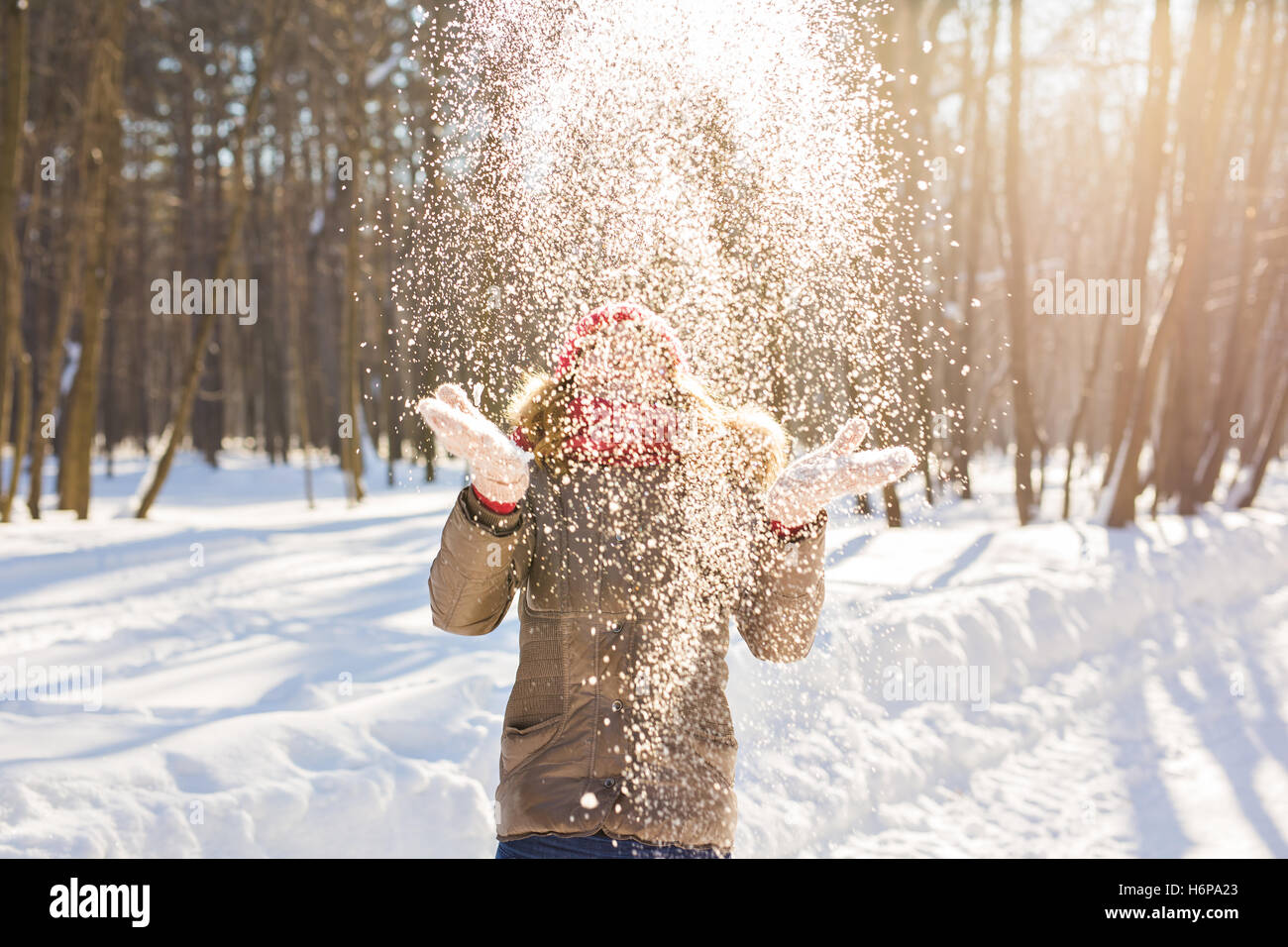 Beauty Girl Blowing Snow in frosty winter Park. Outdoors. Flying ...