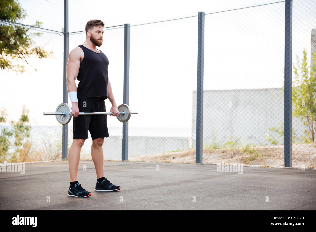 Full length portrait of a muscular fitness man doing heavy exercise ...