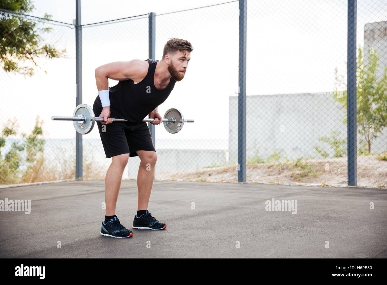 Full length portrait of a muscular fitness man doing heavy exercise ...