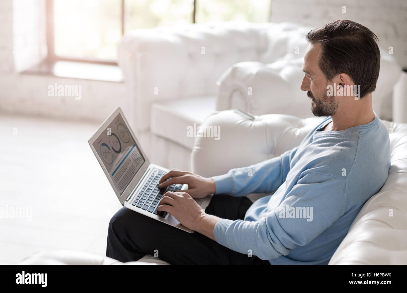 Serious hard working man looking at the laptop screen Stock Photo - Alamy