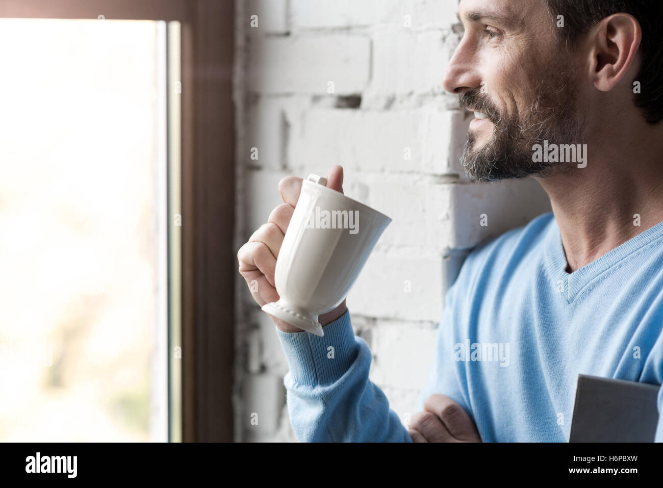 Delighted optimistic man looking into the window Stock Photo - Alamy
