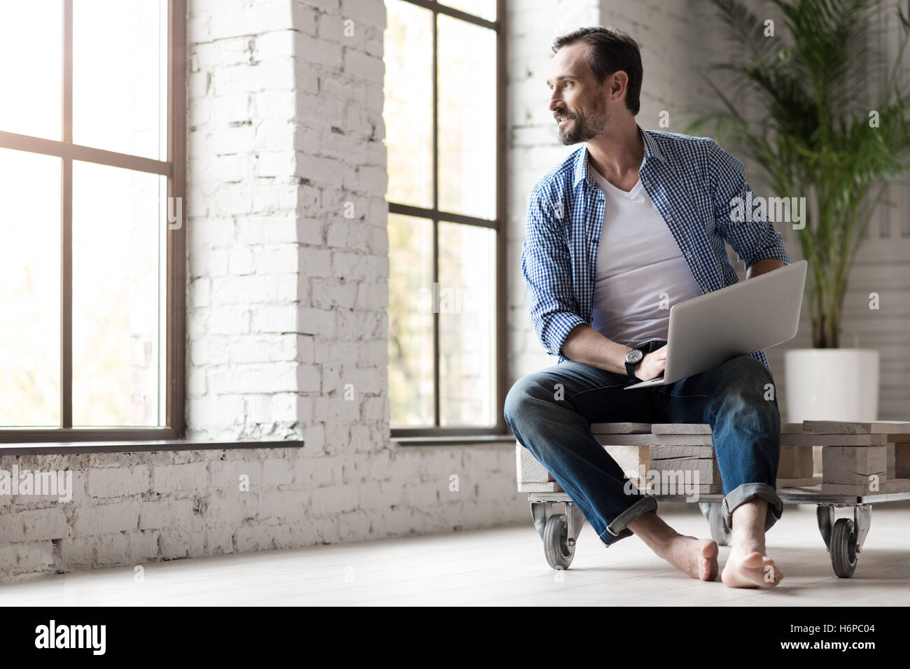 Delighted handsome man looking into the window Stock Photo - Alamy