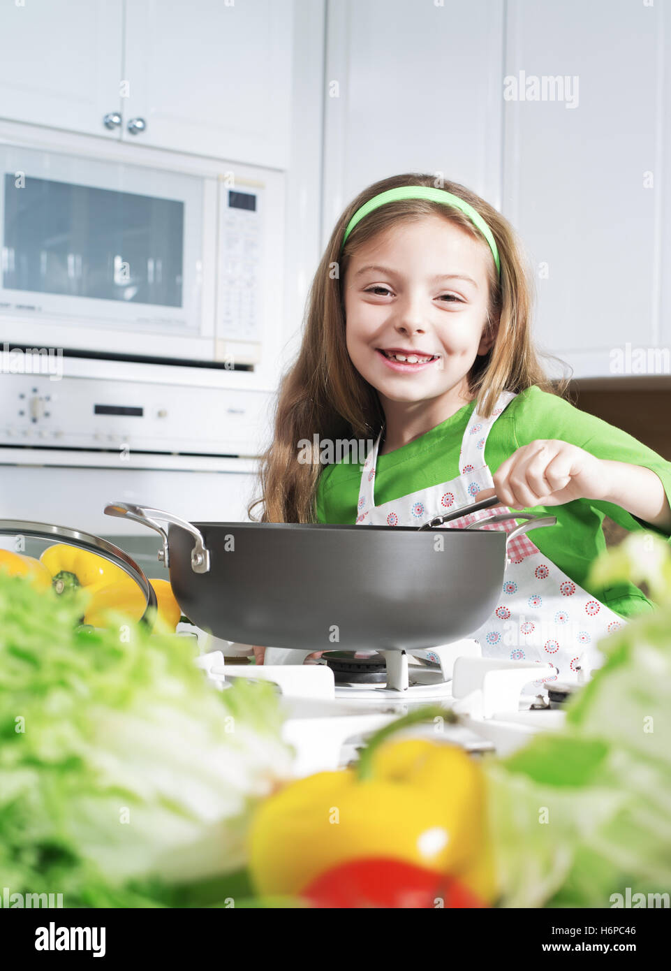 view of young beautiful girl cooking at the kitchen Stock Photo - Alamy