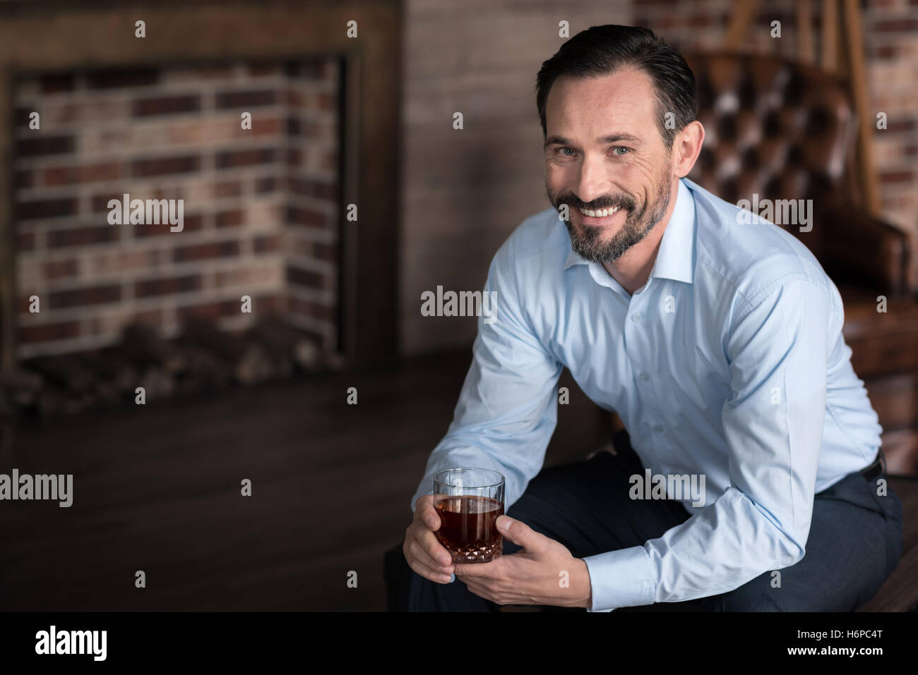 Cheerful successful businessman enjoying his alcoholic drink Stock ...