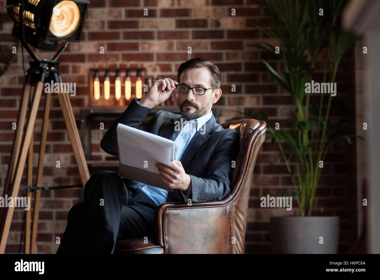 Attractive good looking man holding his glasses Stock Photo - Alamy