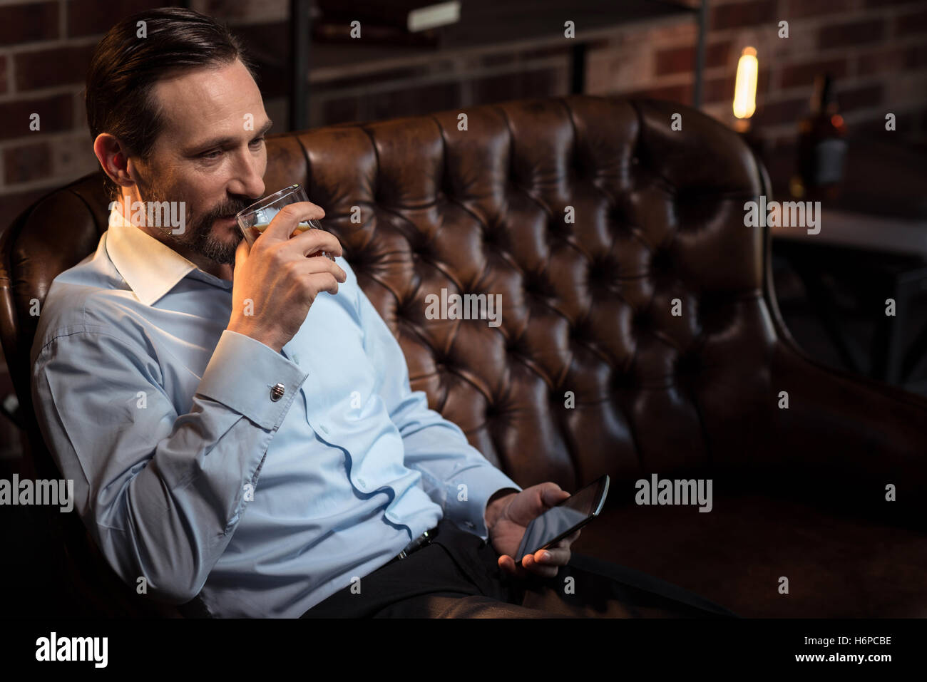 Man drinking alone sofa hi-res stock photography and images - Alamy