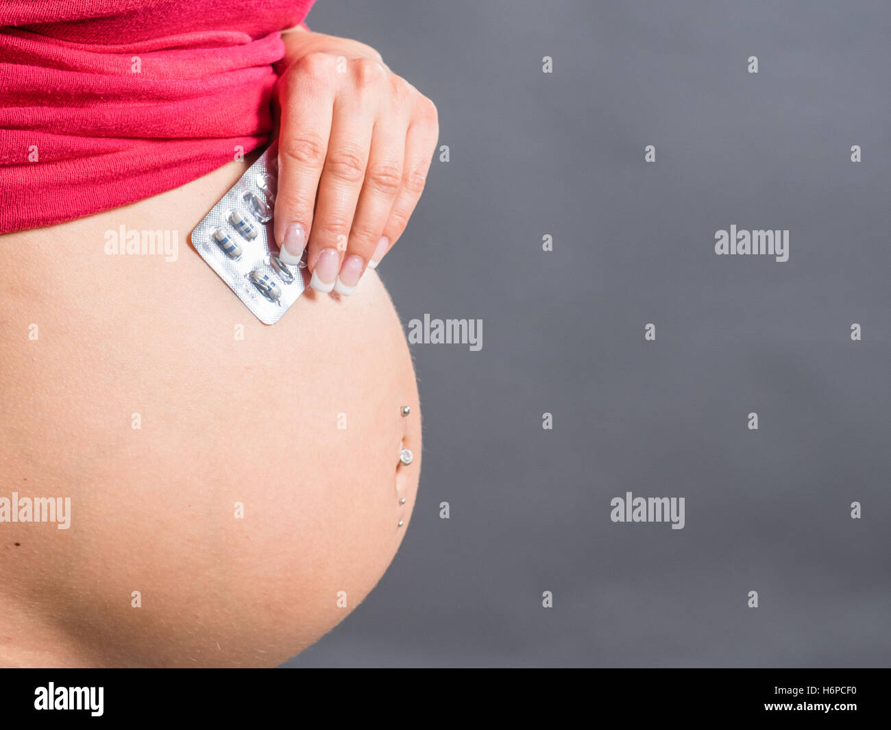 Pregnant woman on medication with tablets in hand Stock Photo - Alamy