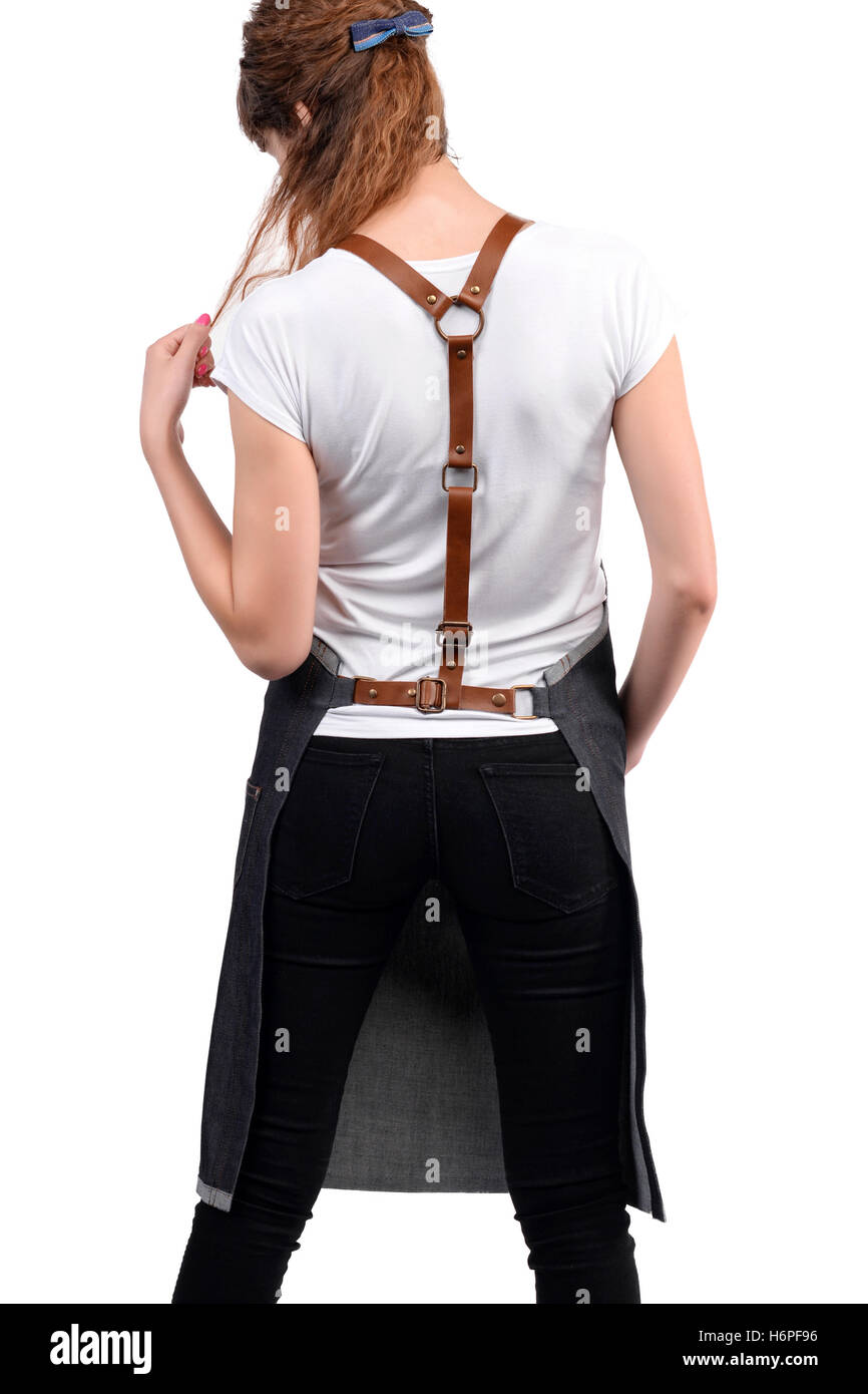 Young redhaired woman chef or waiter posing, wearing apron and t-shirt ...