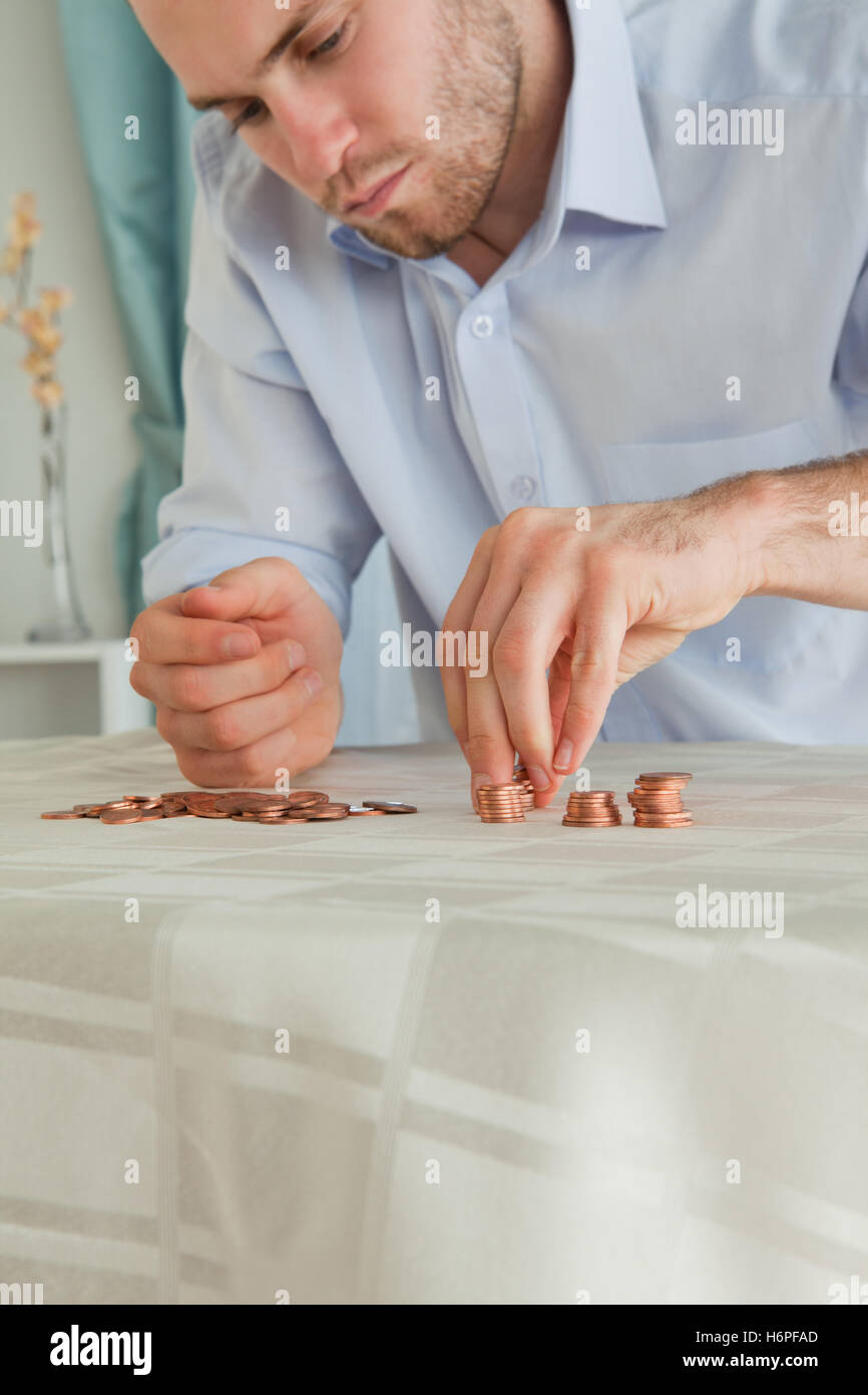 Desperate young businessman counting his small change Stock Photo - Alamy