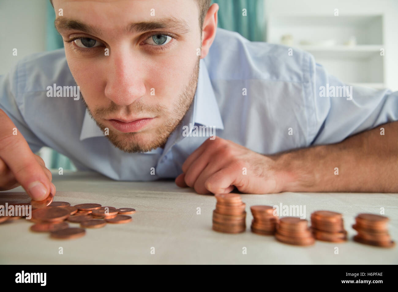 Young businessman counting his change Stock Photo - Alamy