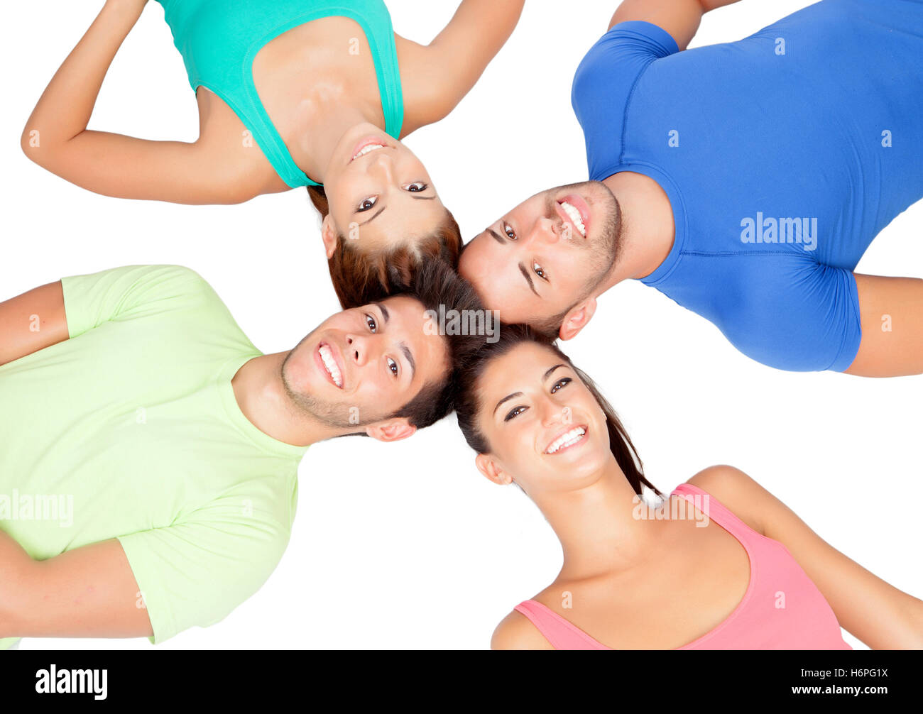 Happy friends on the floor with their heads together isolated on white ...