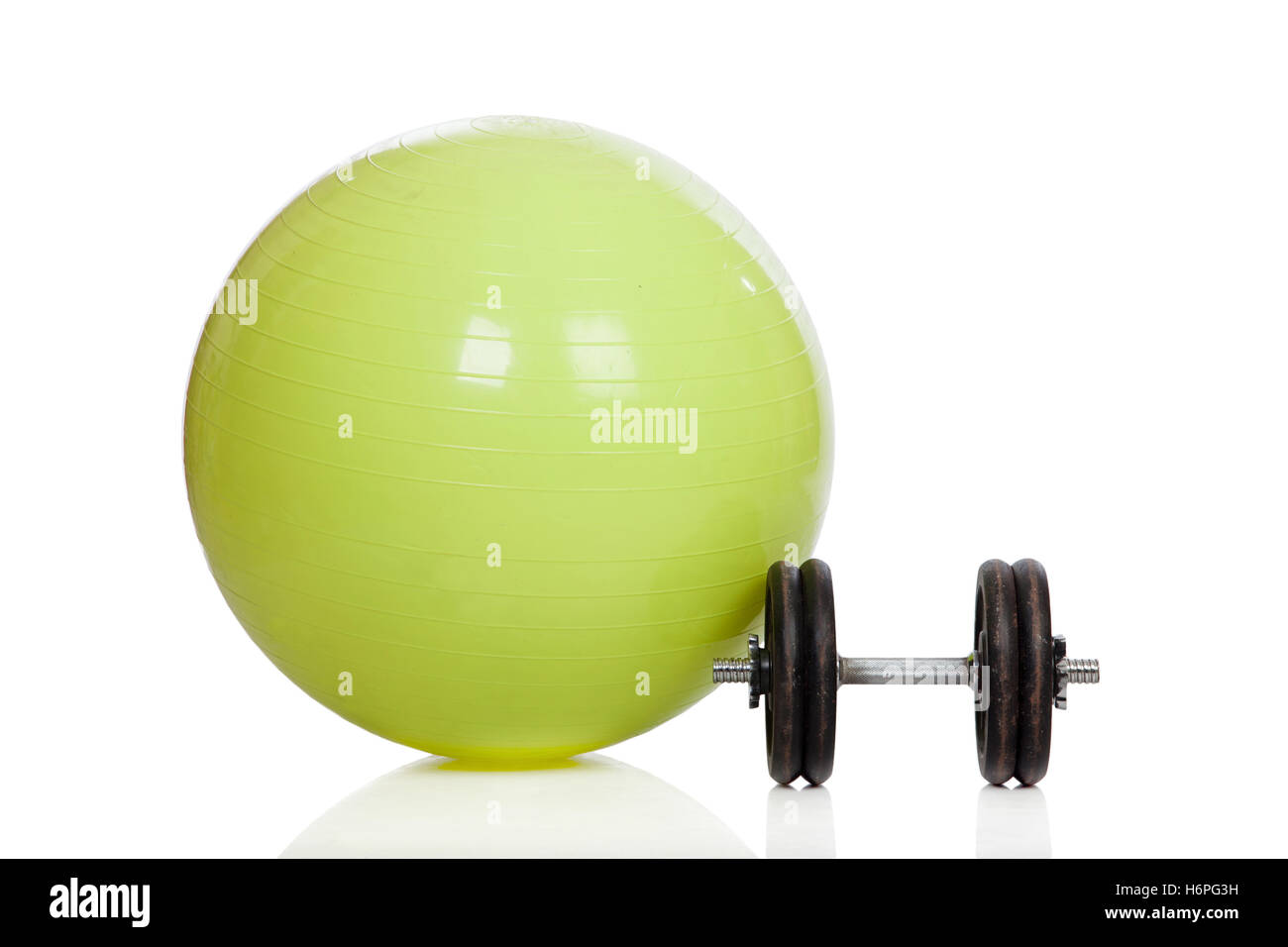 Big green training ball and dumbbell isolated on a white background ...