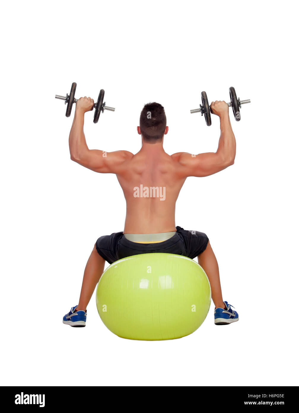 Strong man practicing exercises with dumbbells sit on a ball isolated ...