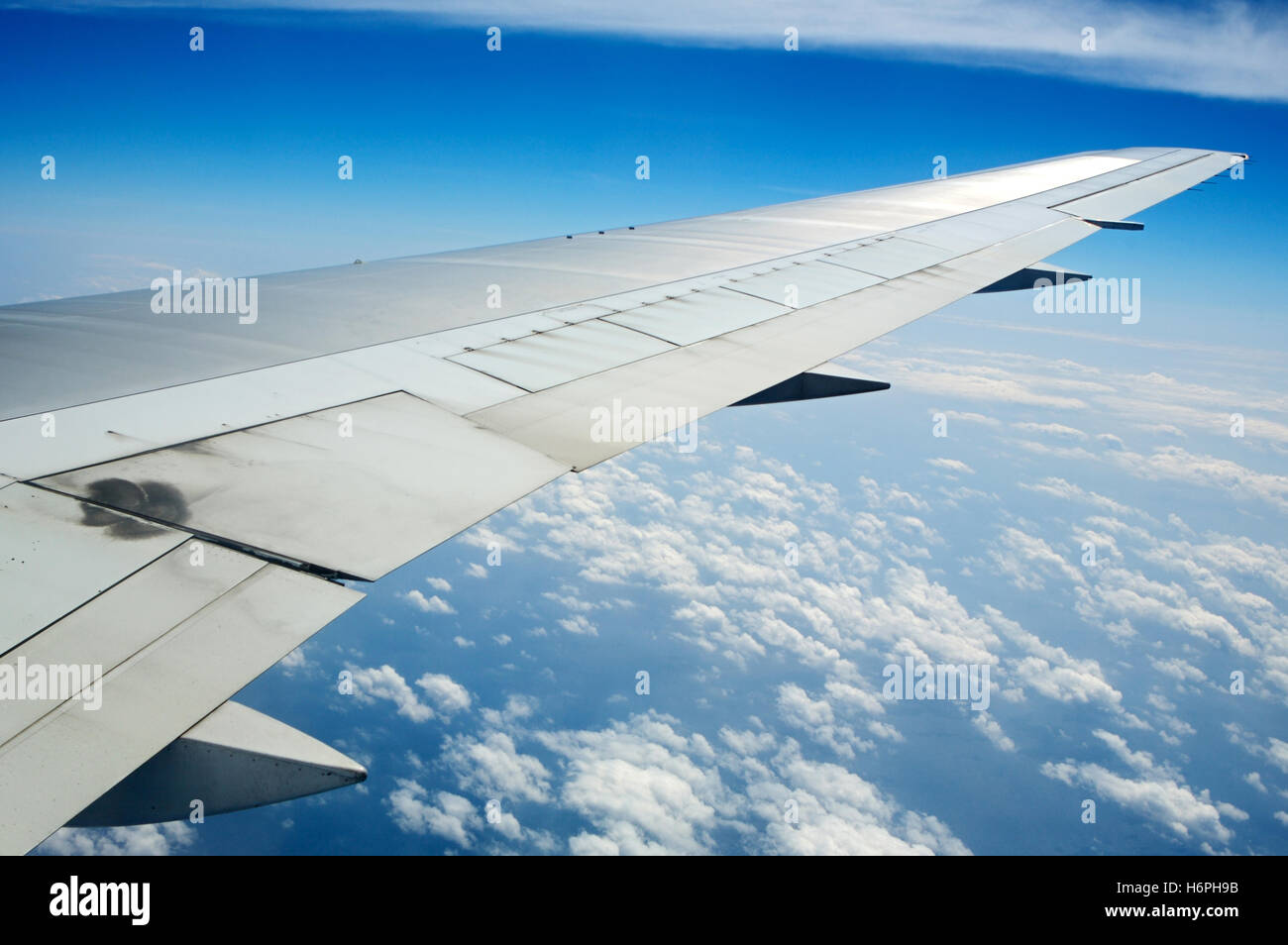 Wing of an airplane with a nice aerial view of the sky with clouds ...