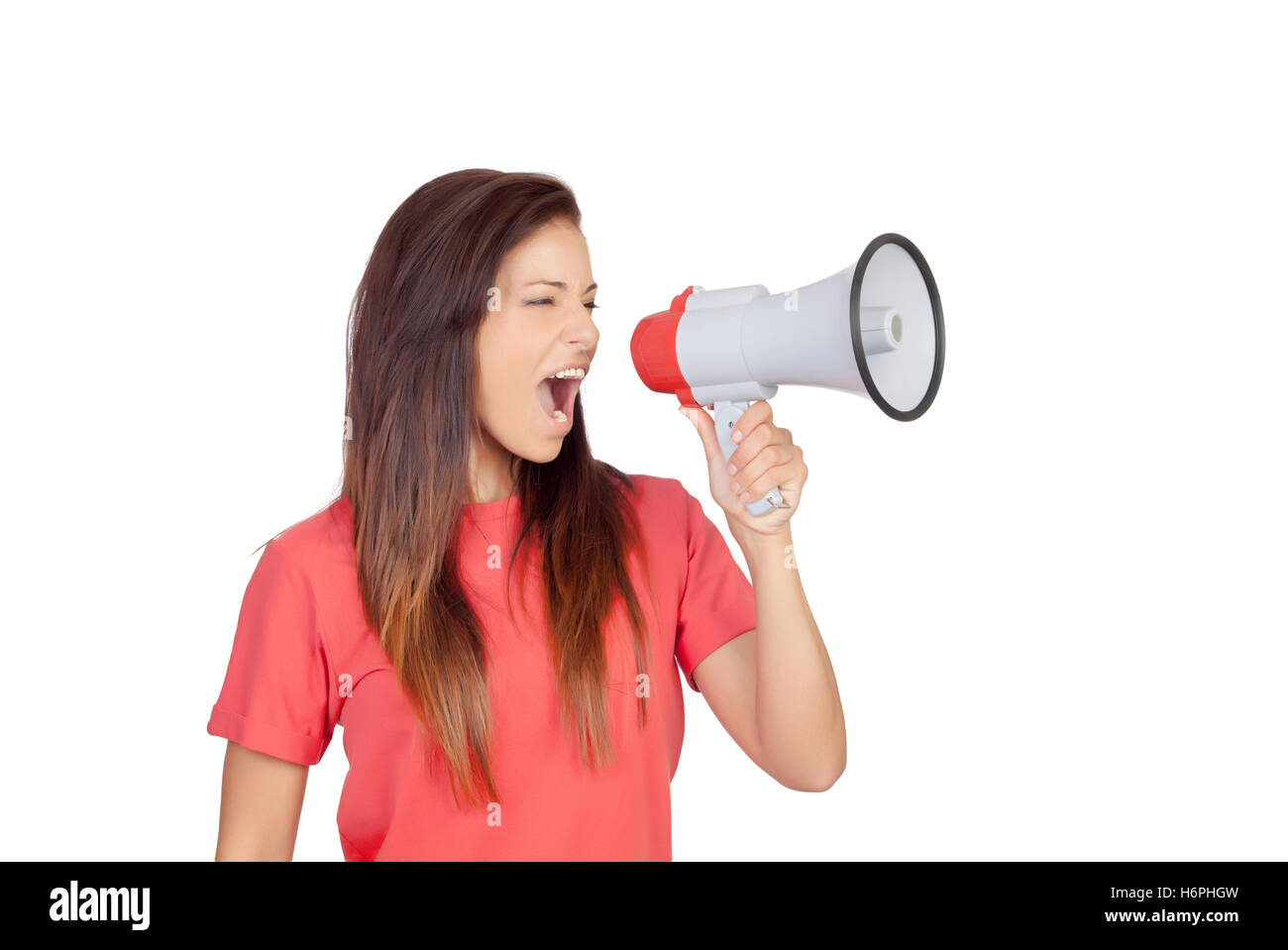 Attractive brunette girl shouting with a megaphone isolated on a over ...