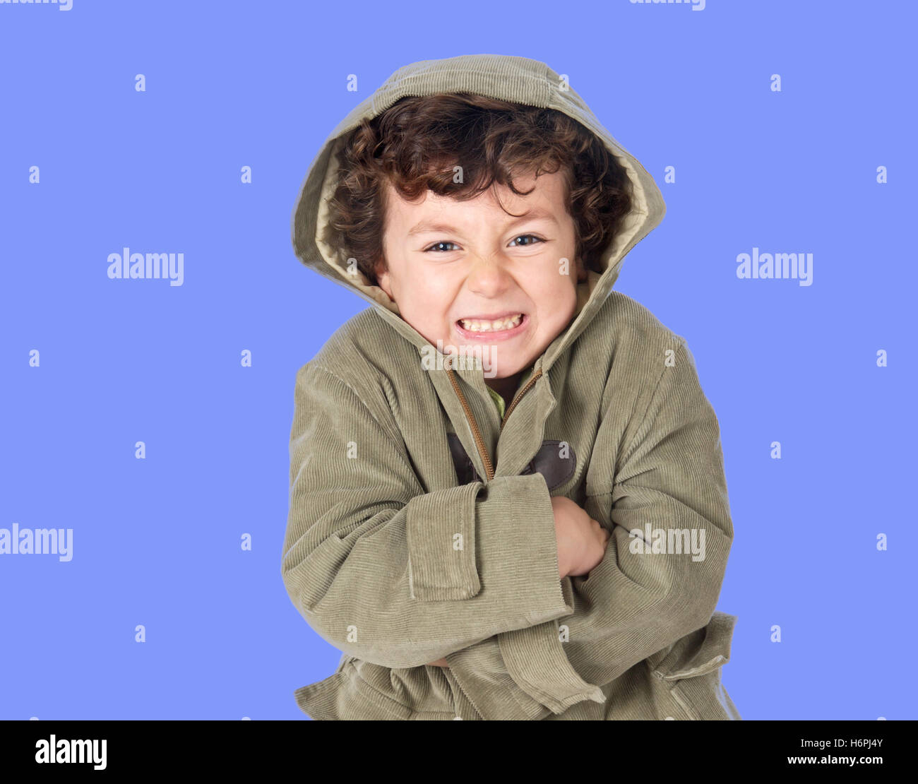 Funny little boy shivering with cold on a blue background Stock Photo ...