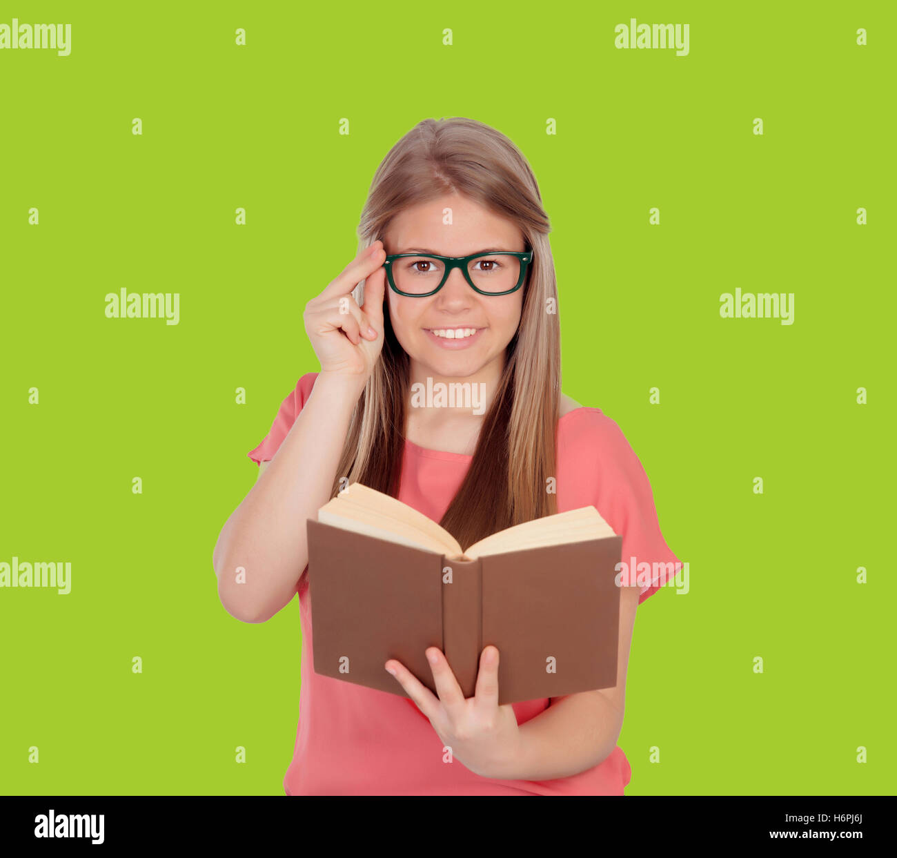 College student charged with books on green background Stock Photo - Alamy