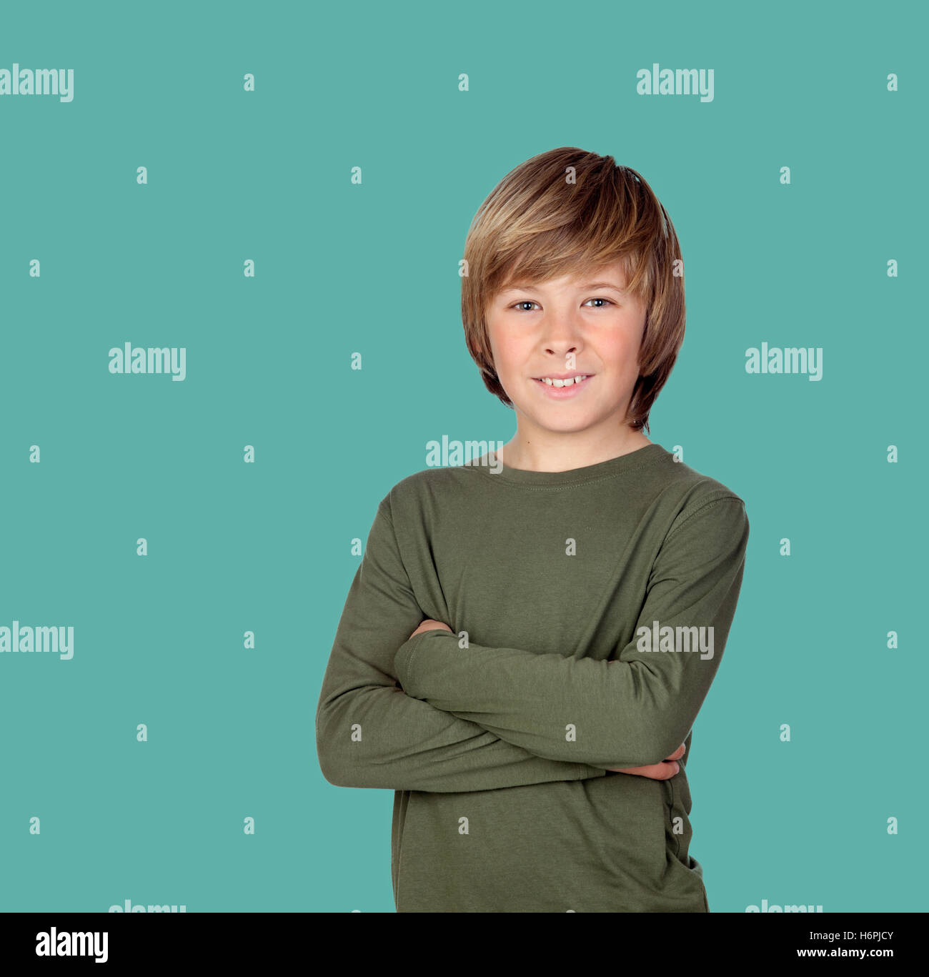 Smiling adolescent with a happy gesture on a green background Stock ...