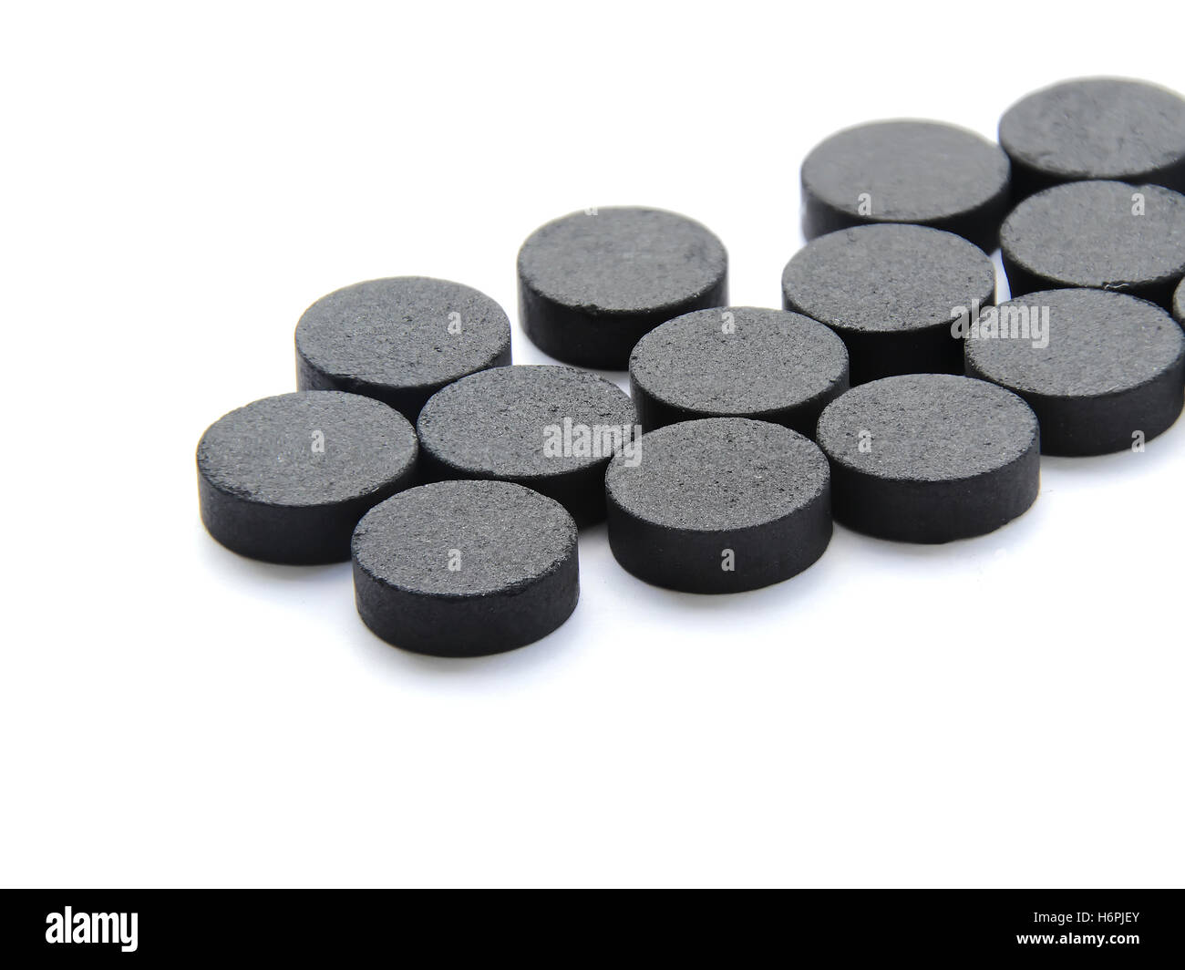 Closed up Activated charcoal carbon pills isolated on white background ...