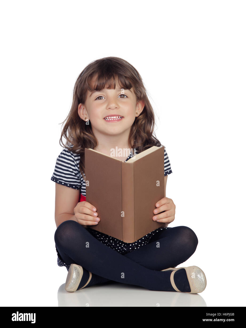 Adorable little girl with a book reading isolated on white background ...