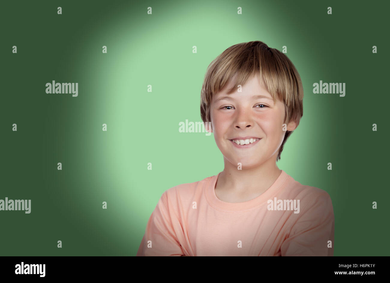 Smiling adolescent with a happy gesture on a over green background ...