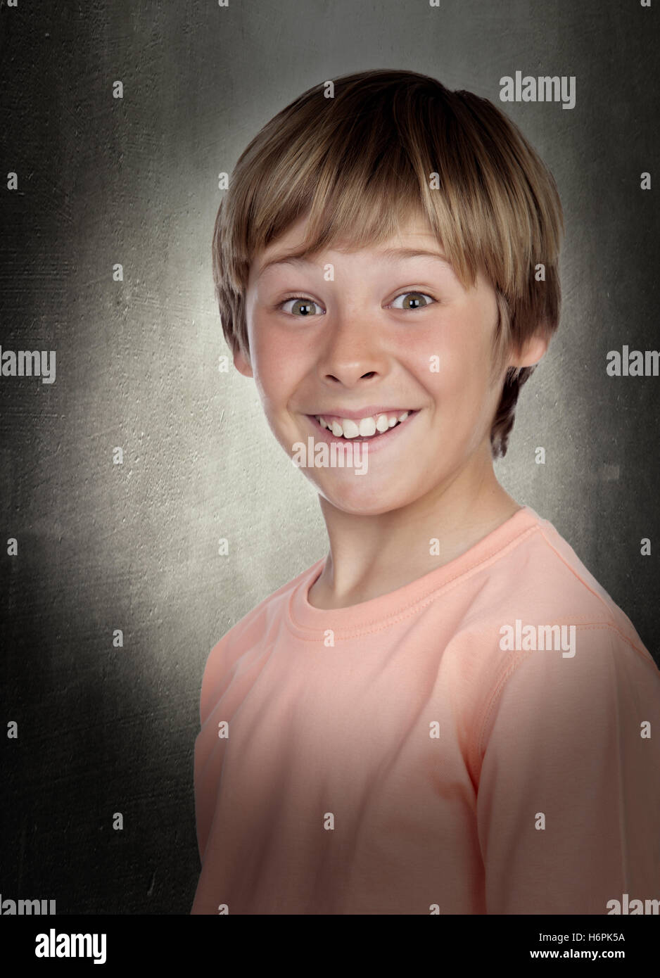Smiling adolescent with a happy gesture on gray background Stock Photo ...