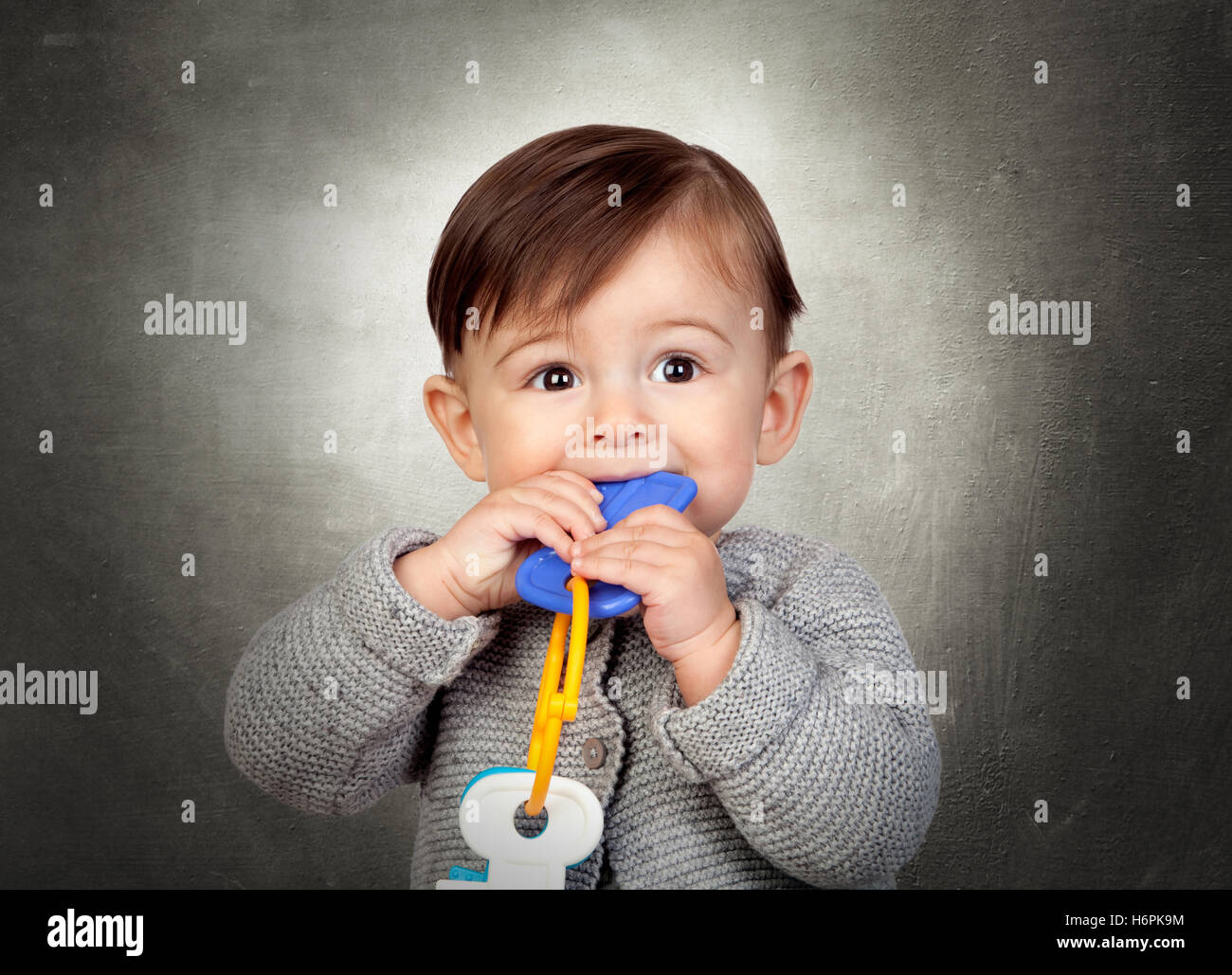 Little Boy Playing With Toy Key Over Coloured Background Stock Photo ...