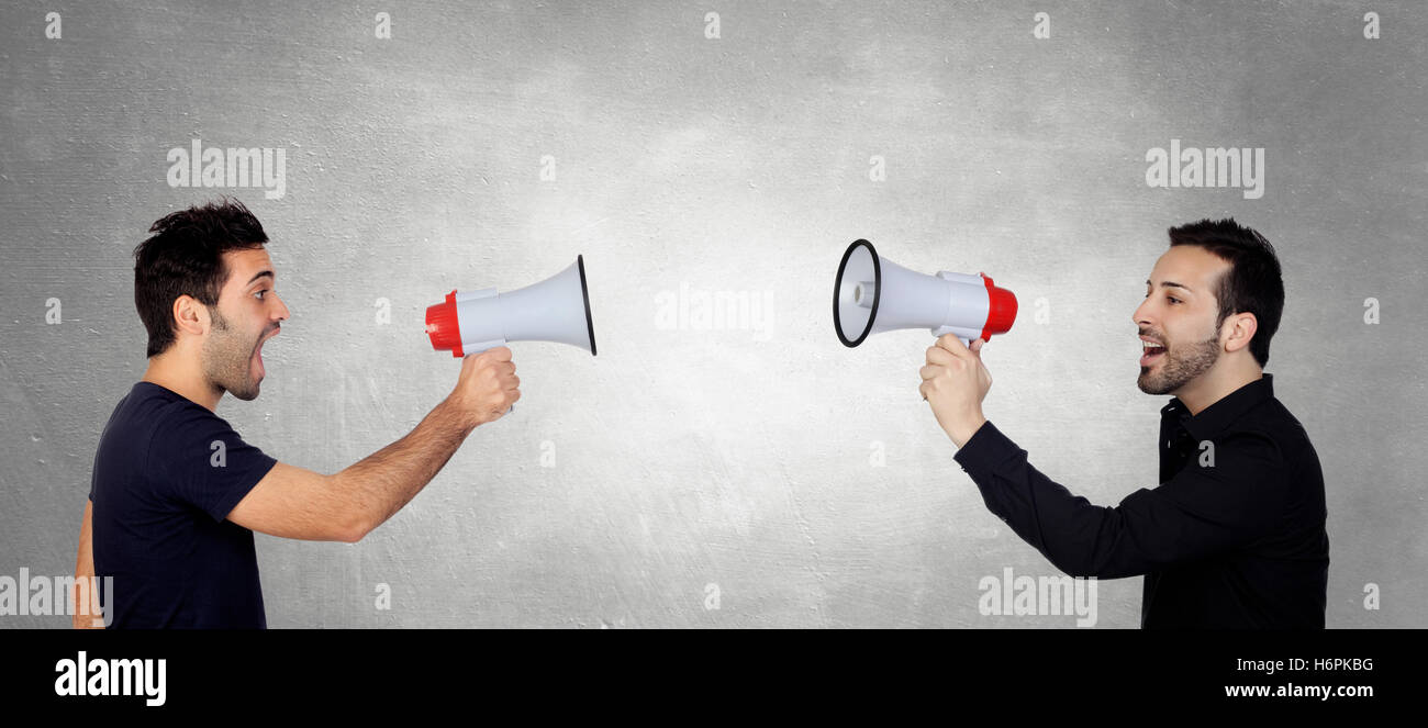 Two Young Men Shouting Through Megaphone In Front Of Each Other Stock ...