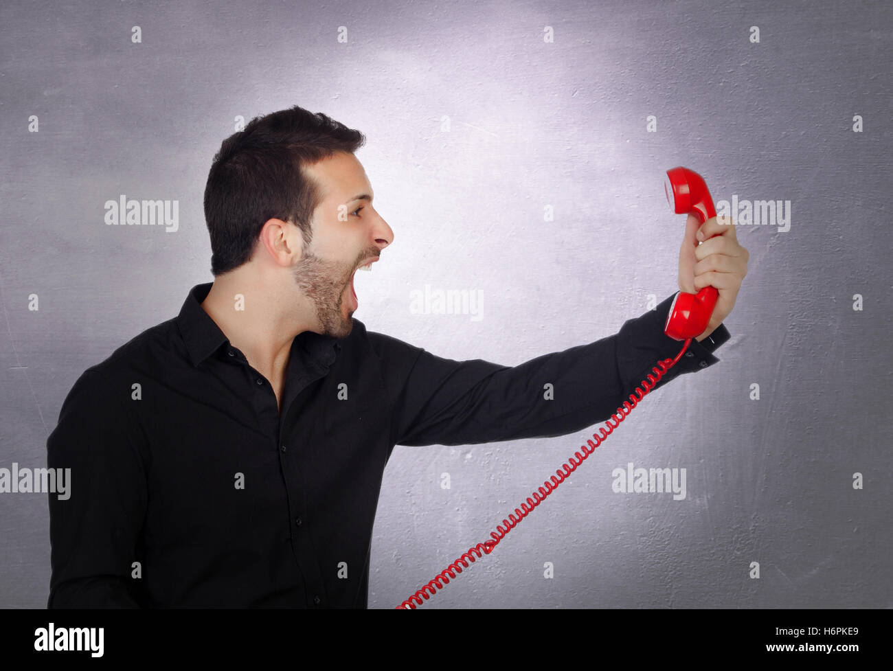 Angry Businessman shouting At Phone over irregular grey background ...