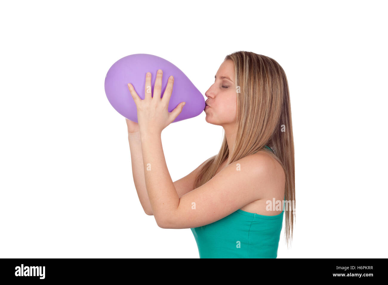 Attractive blond girl swelling a balloon isolated on white background ...