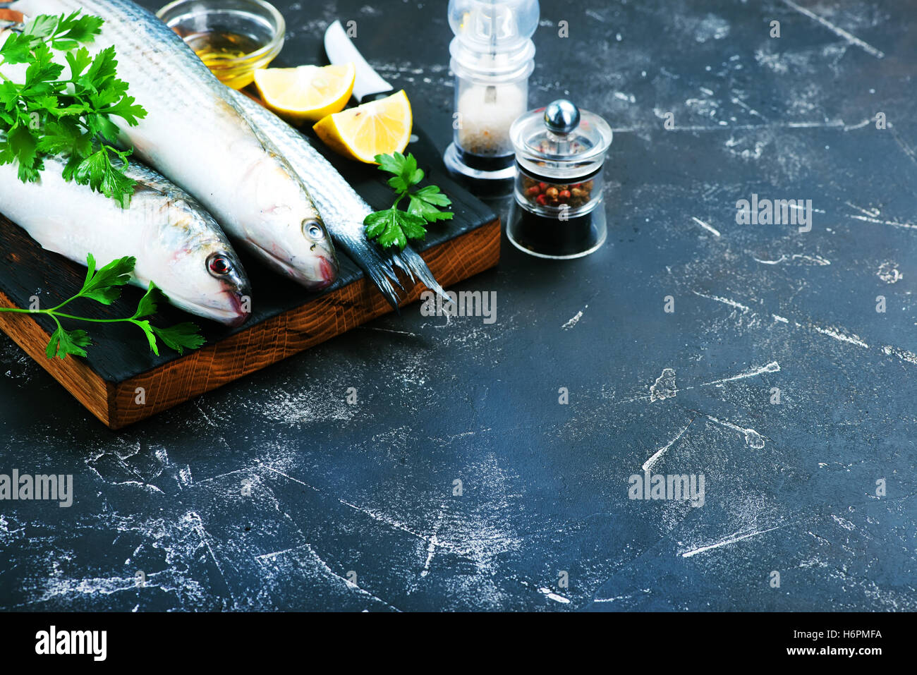 raw fish with aroma spice on a table Stock Photo - Alamy