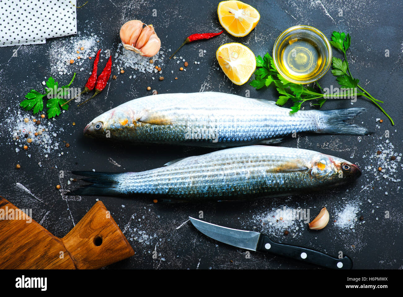 raw fish with aroma spice on a table Stock Photo - Alamy