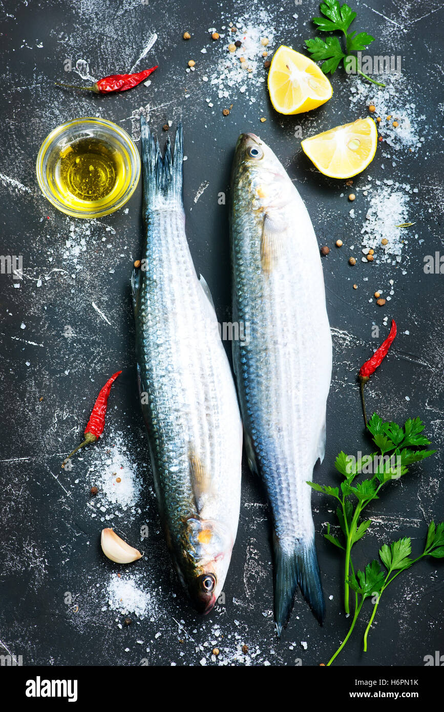 raw fish with aroma spice on a table Stock Photo - Alamy
