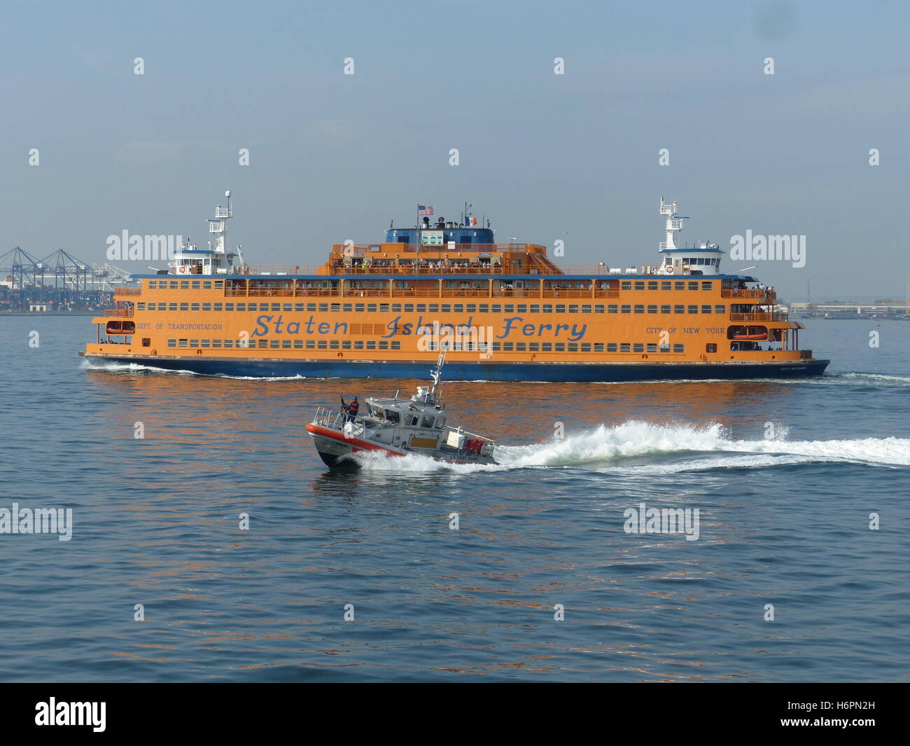 Staten Island Ferry escorted by armed US Coast Guard speed boat Stock ...