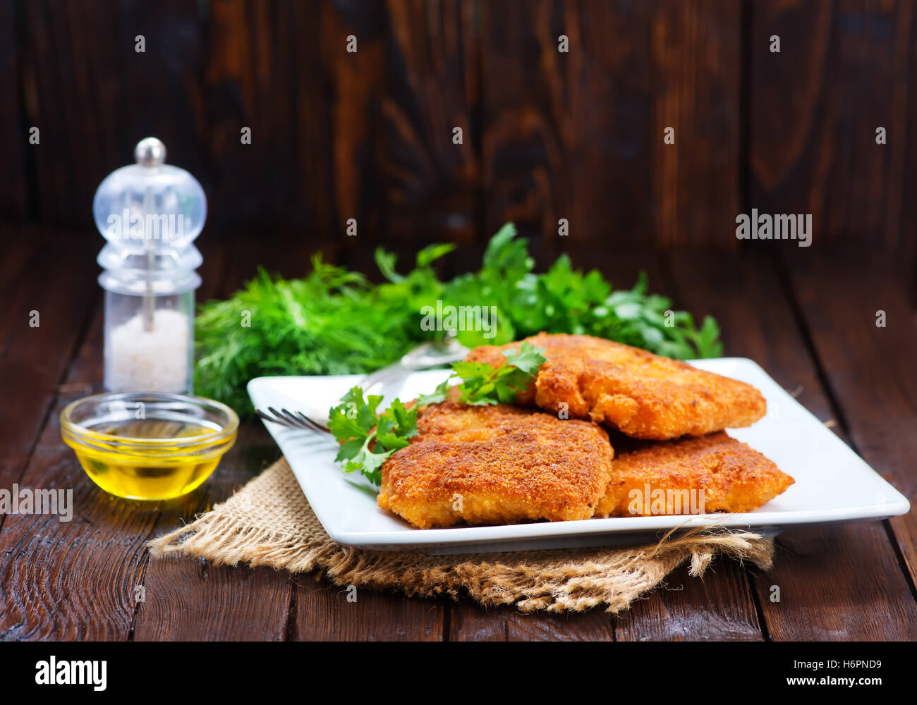 fried fish on plate and on a table Stock Photo - Alamy