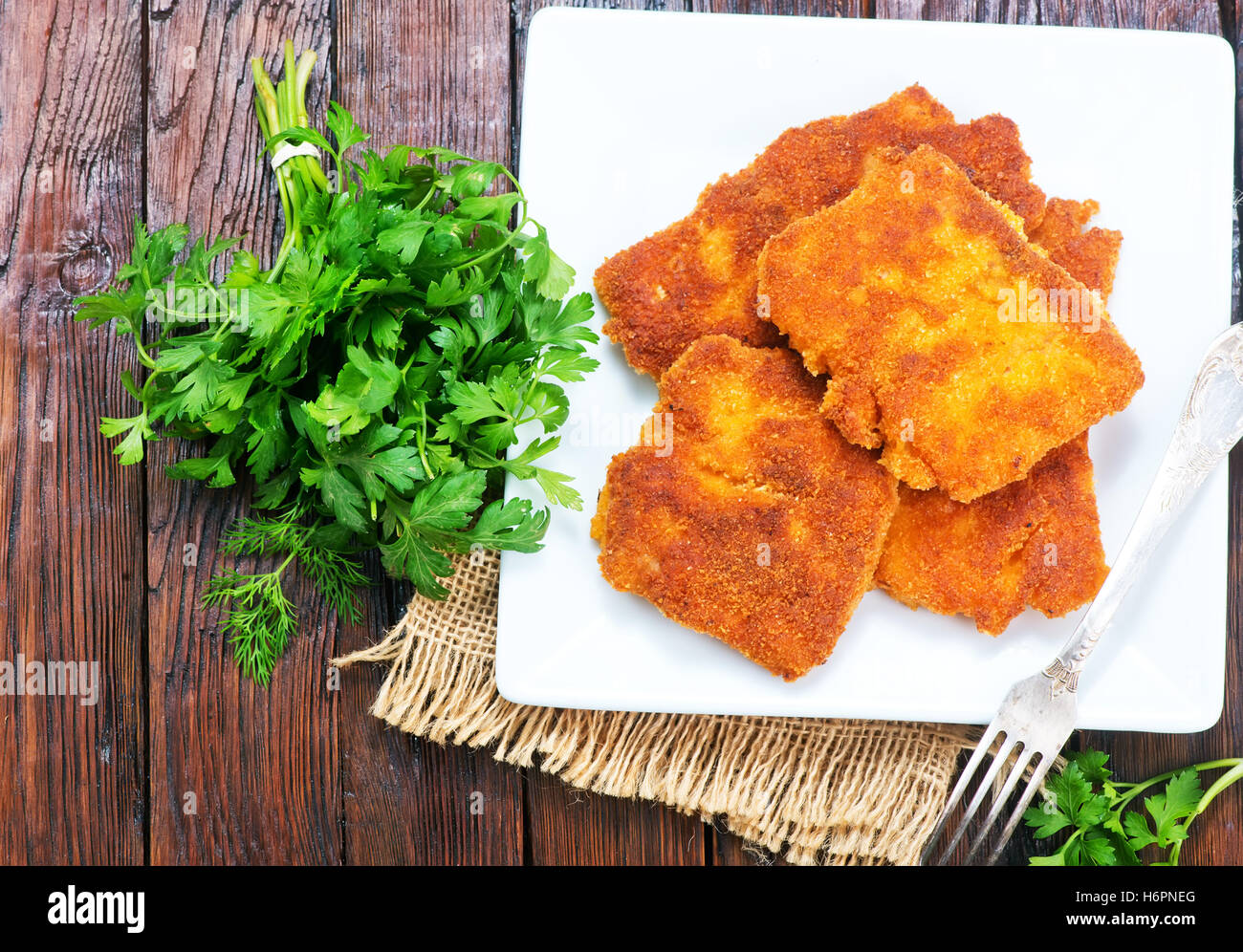 fried fish on plate and on a table Stock Photo - Alamy