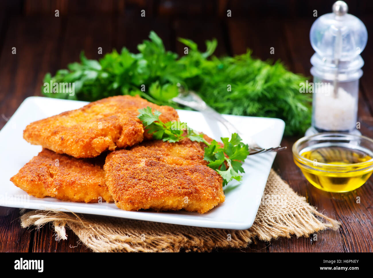 fried fish on plate and on a table Stock Photo - Alamy