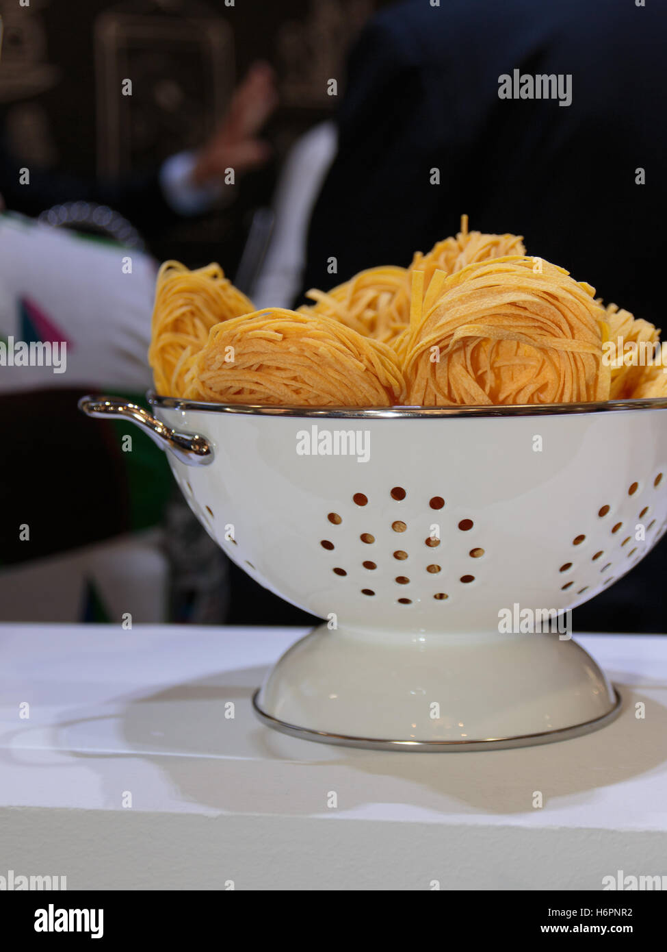 Raw Tagliatelle Italian Pasta inside White Colander on Table Stock ...