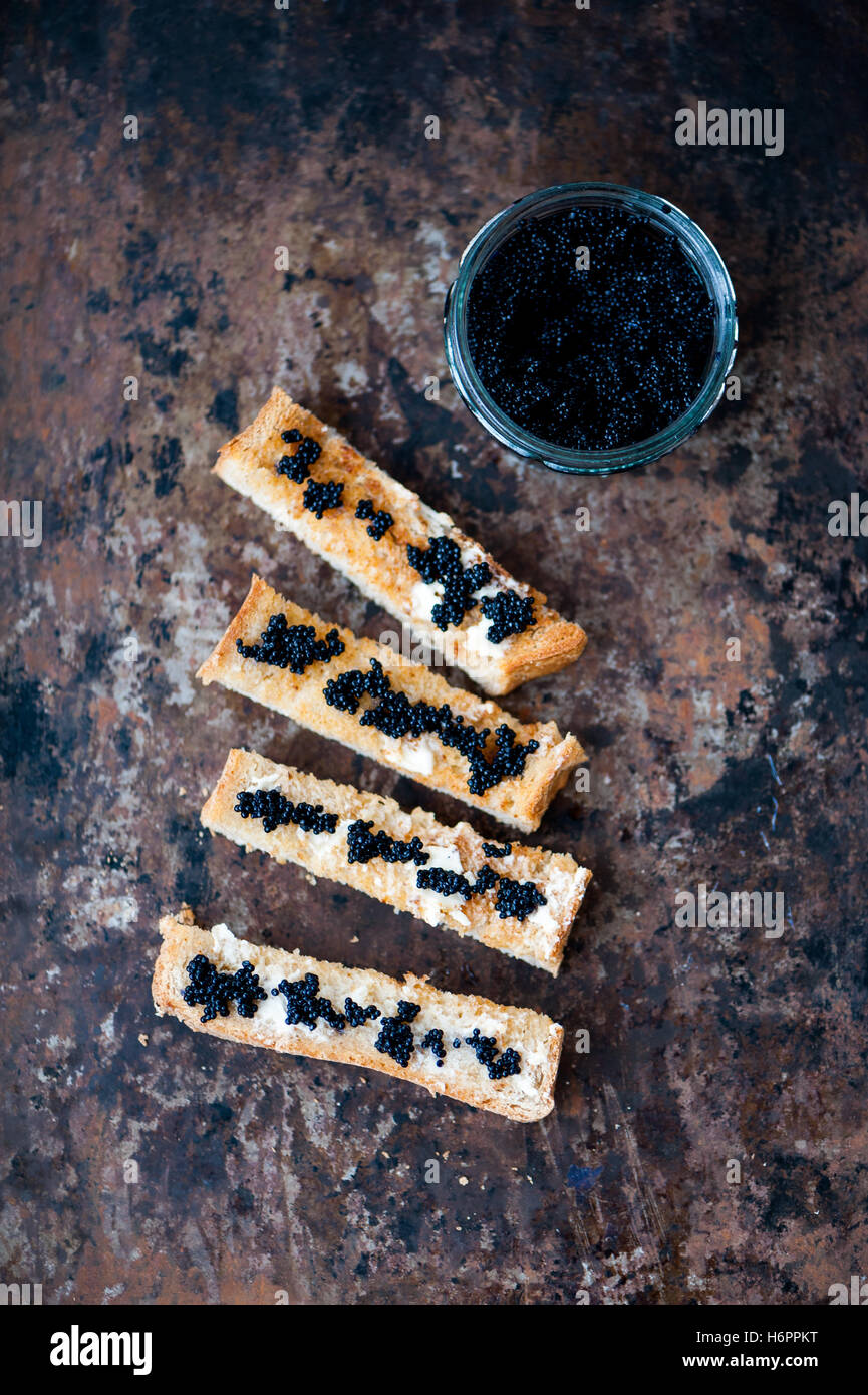 Black caviar on toast with butter Stock Photo - Alamy