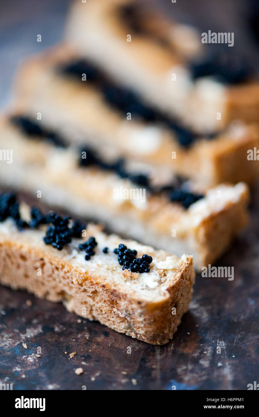 Black caviar on toast with butter Stock Photo - Alamy