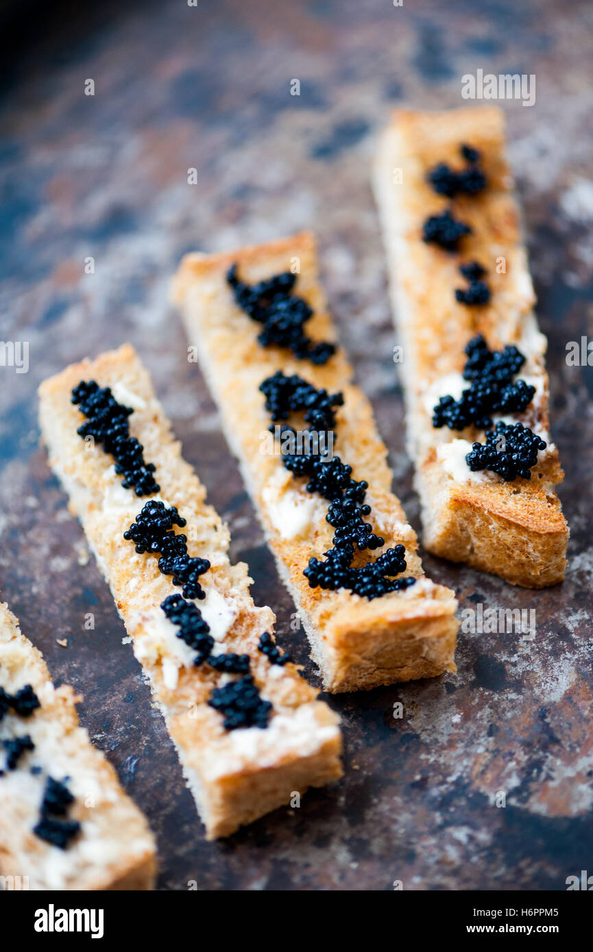Black caviar on toast with butter Stock Photo - Alamy