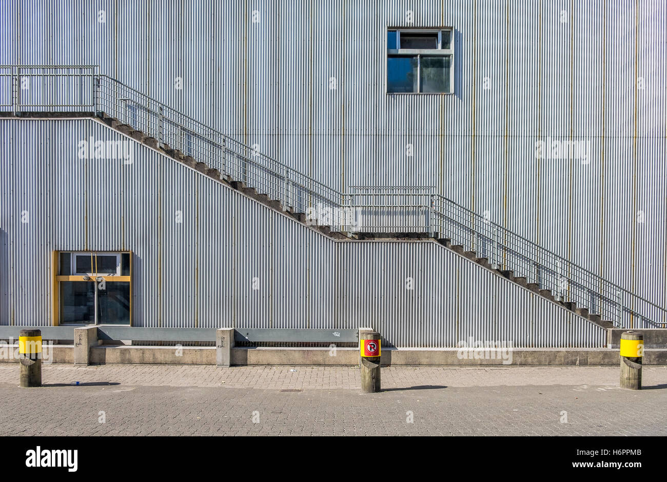 Emergency exit stairs on an exterior of a corrugated wrapped building ...